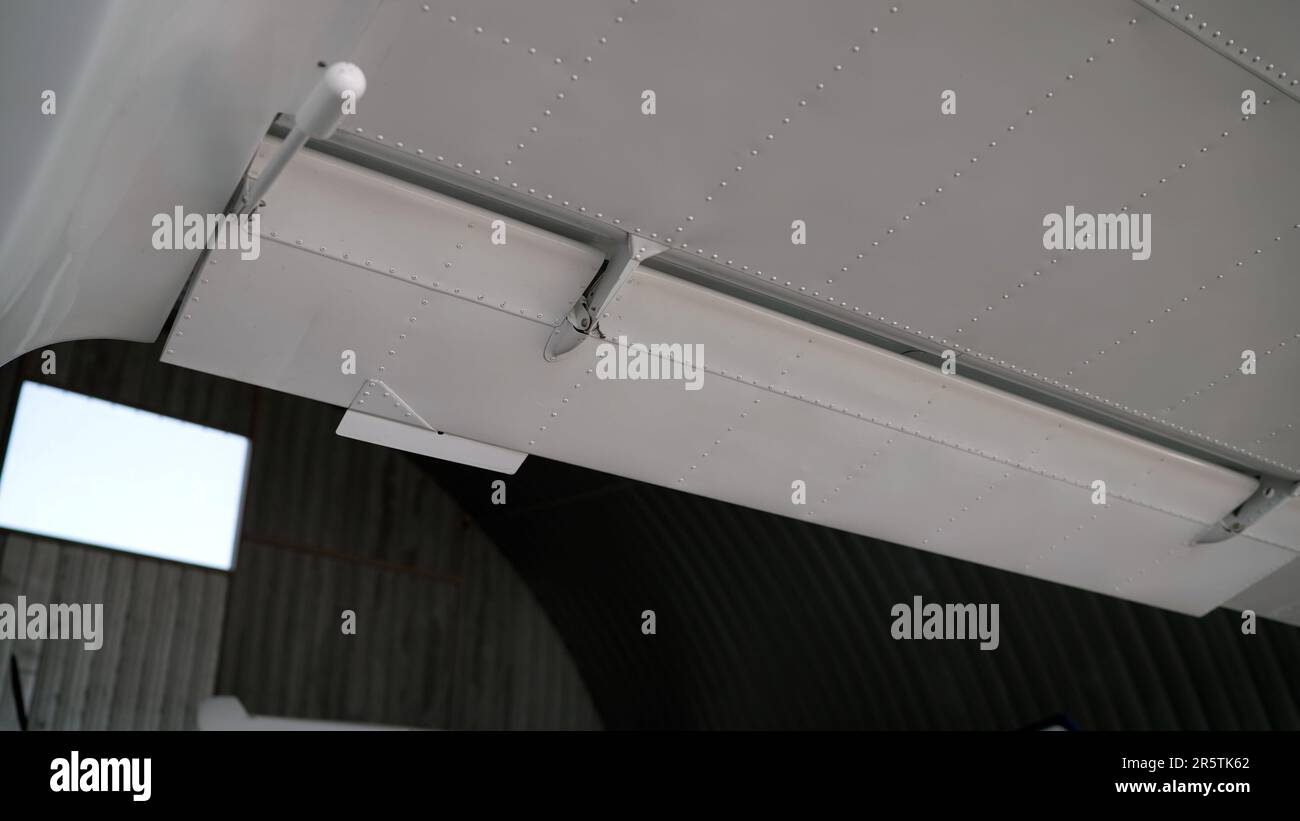 A flap on a private jet in a hangar. Part of the plane. The dampers ...