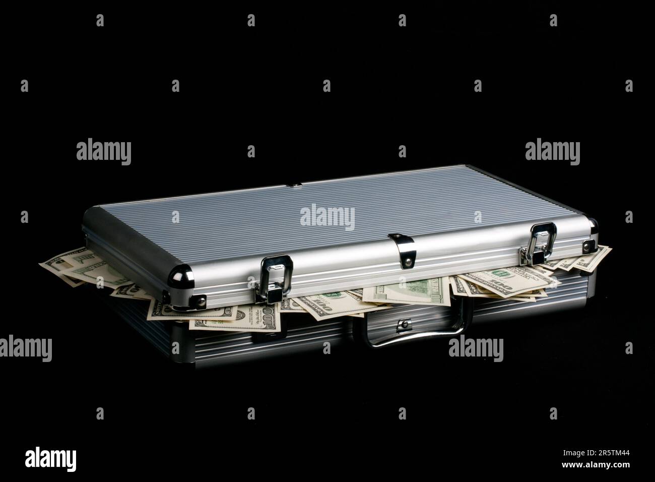 A silver aluminum briefcase full of US dollar bills is featured on a ...