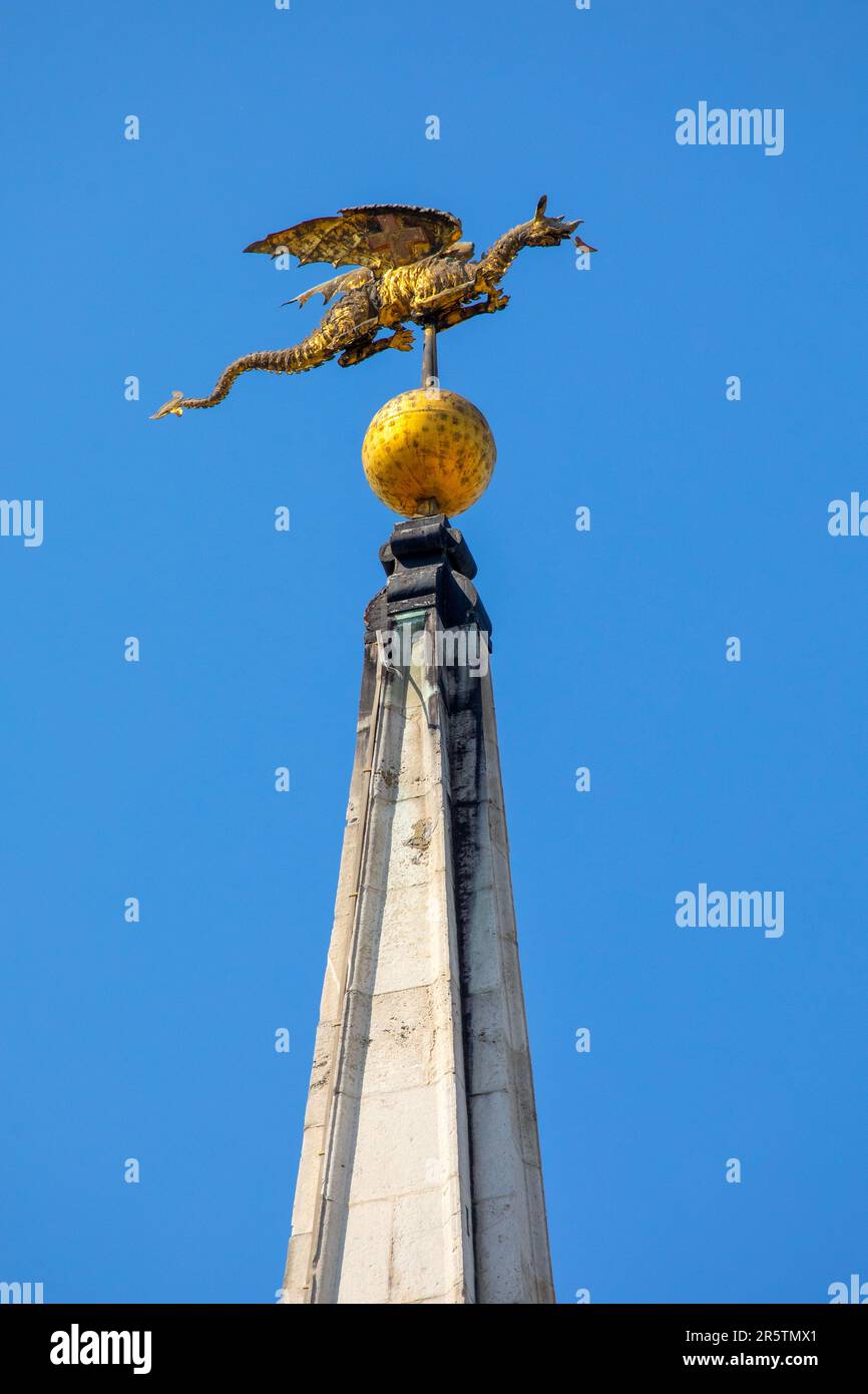 A beautiful golden Dragon sculpture proudly sitting on the spire of the ...