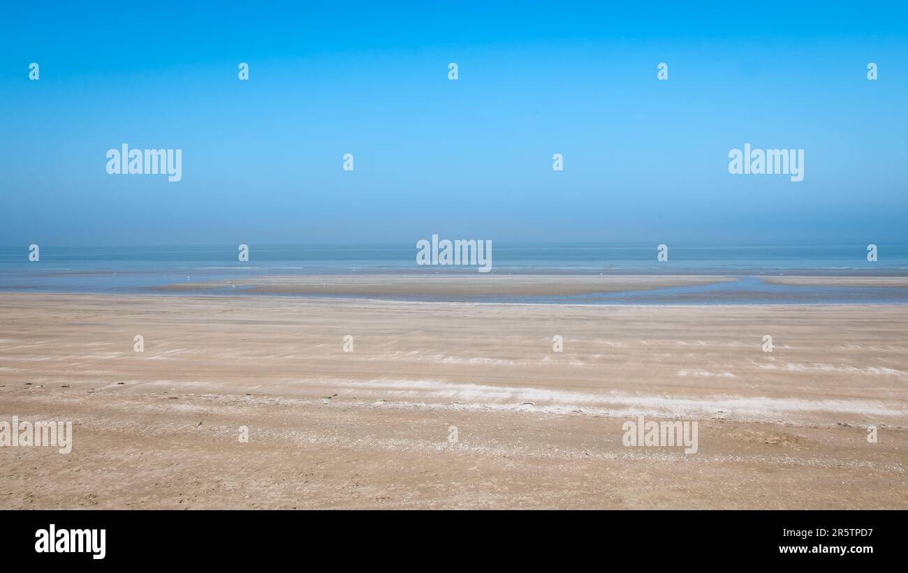 A scenic beach with sand spread out along the shoreline, with crystal ...