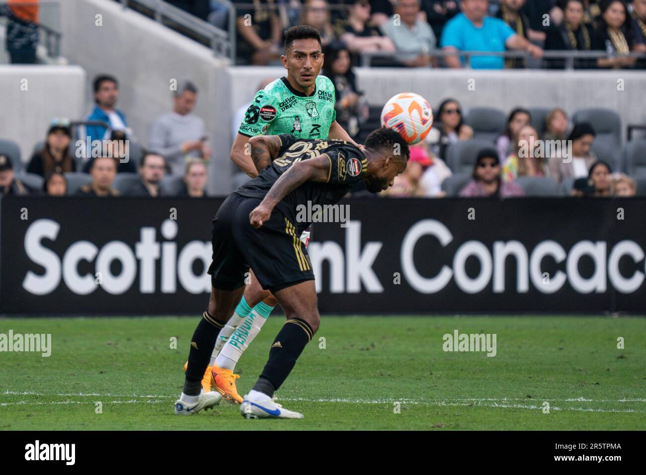 LAFC midfielder Kellyn Acosta (23) wins a header against León ...