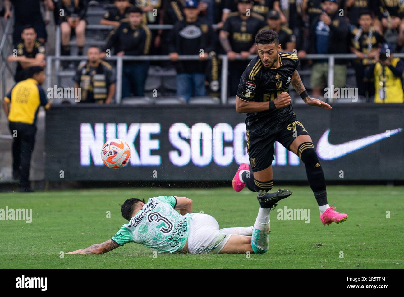 LAFC forward Denis Bouanga (99) evades a slide tackle by Club León ...