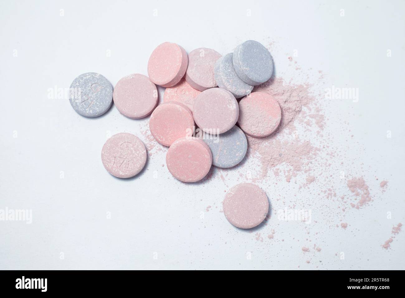 pink and blue multivitamin tablets on a white background Stock Photo ...