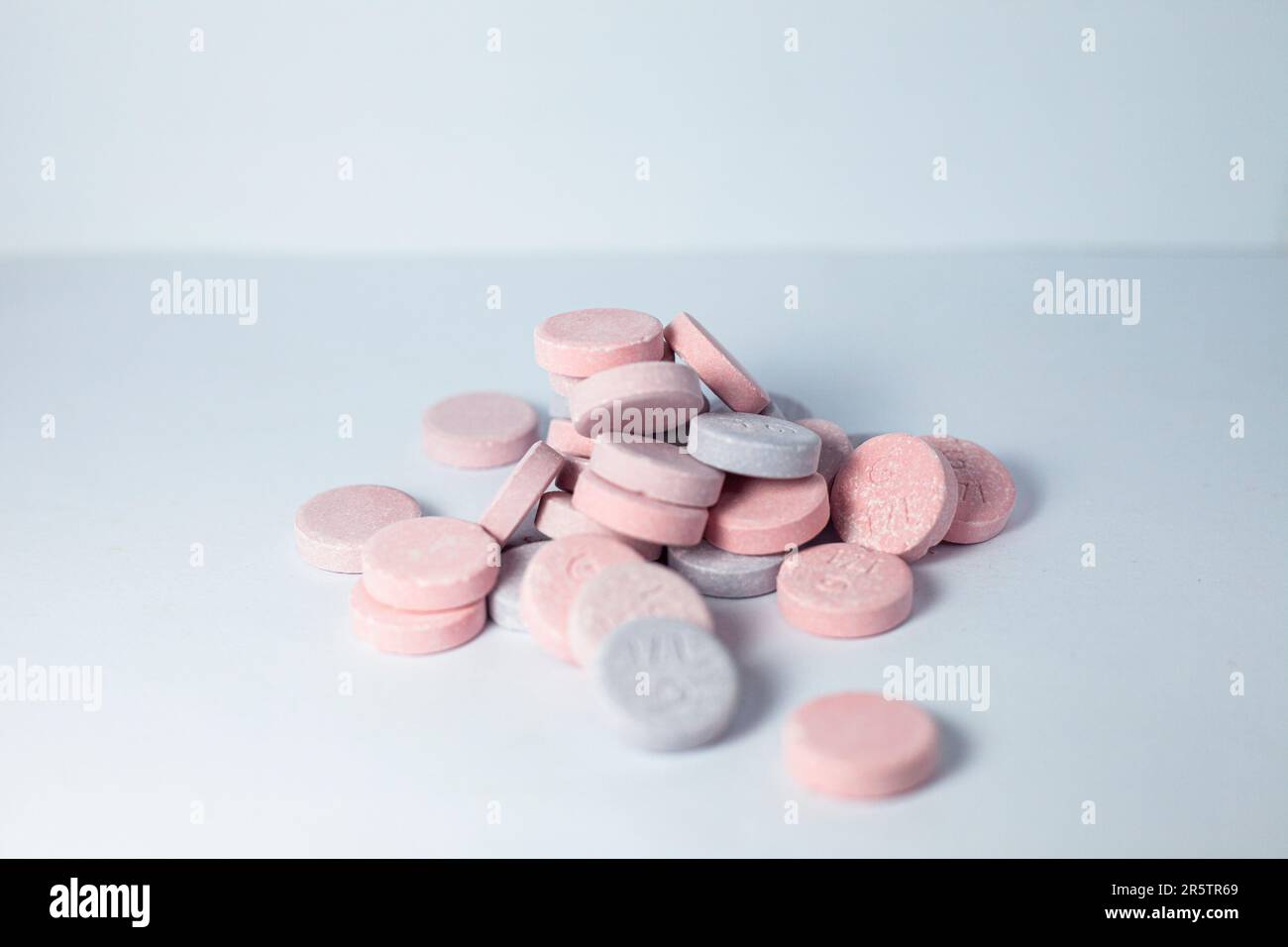pink and blue multivitamin tablets on a white background Stock Photo ...