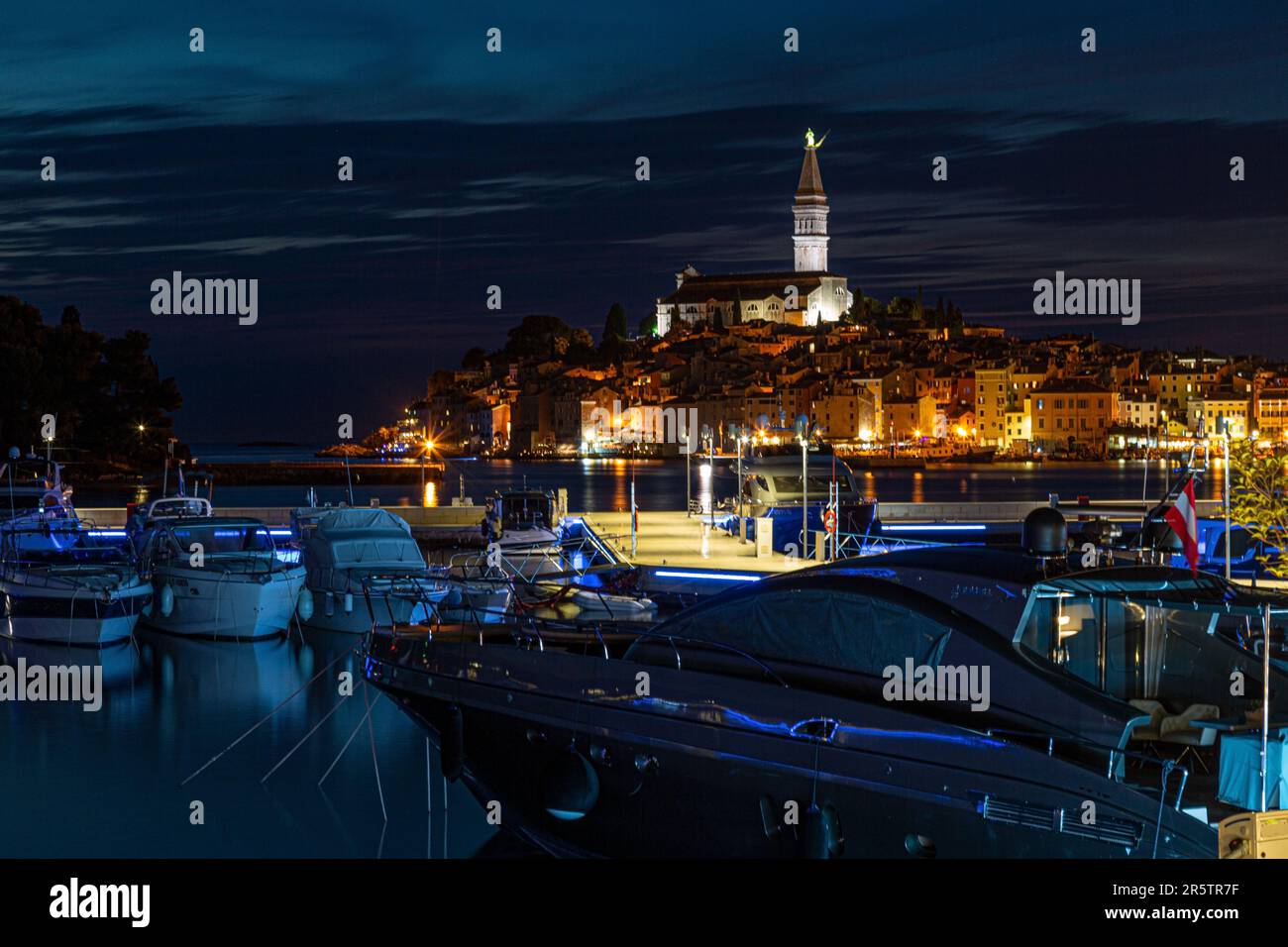 Picture of the illuminated historic part of Rovinj at night in summer ...