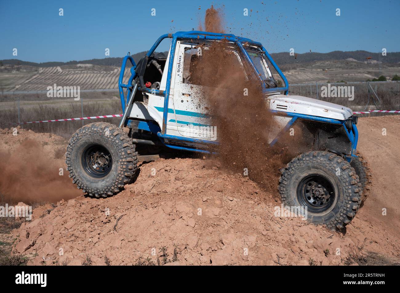 A white Suzuki Samurai with anti-roll bars modified for crawling Stock ...