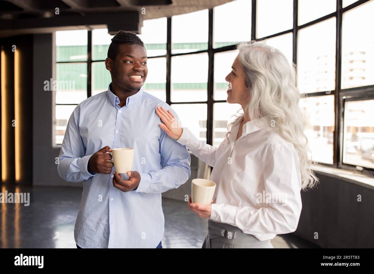 Multiethnic Business Colleagues Enjoying Coffee Break Talking In Office ...