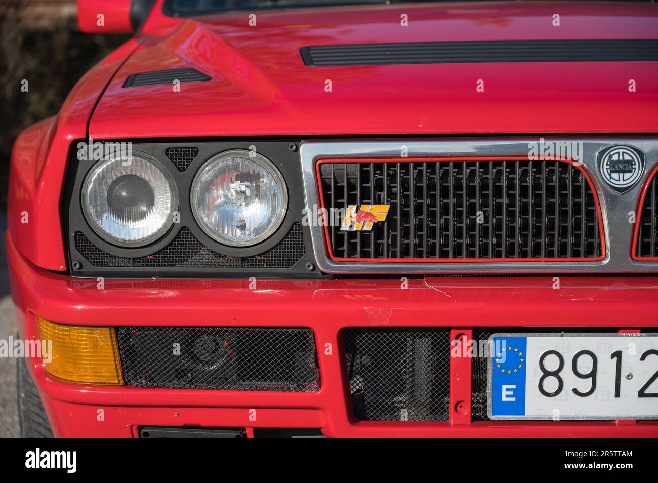 The front view of a red Lancia Delta HF on the street Stock Photo - Alamy