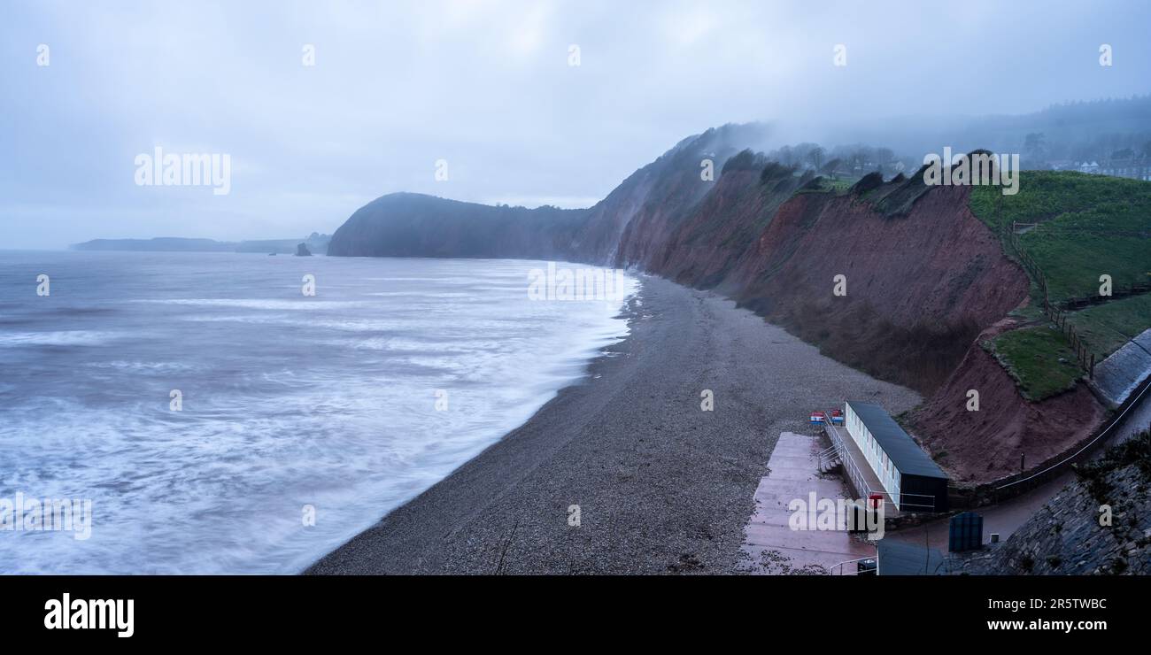 Low cloud blows in from Lyme Bay at Jacob's Ladder beach in Sidmouth on ...