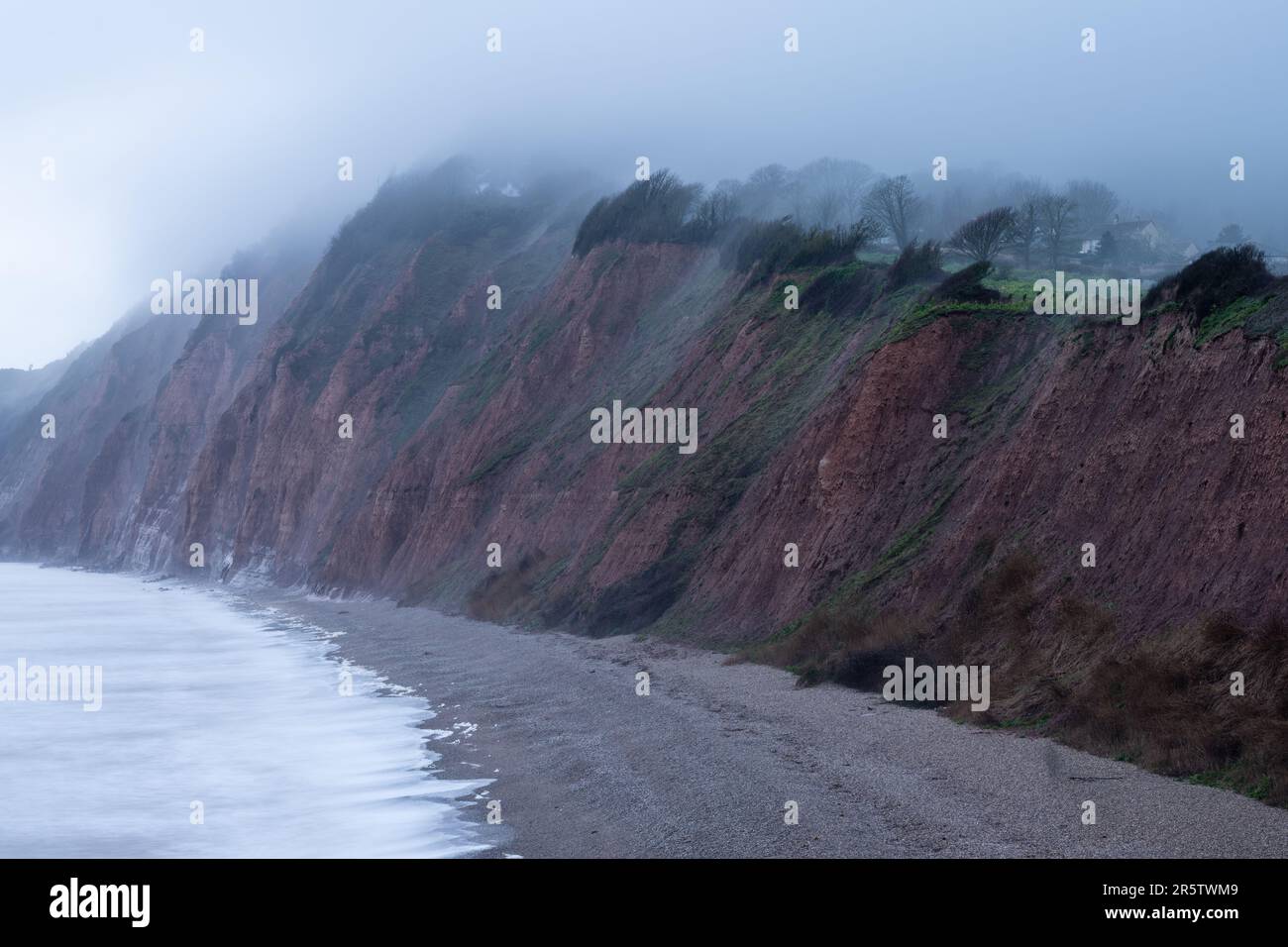 Rain blows off the English Channel and over the sandstone cliffs of ...