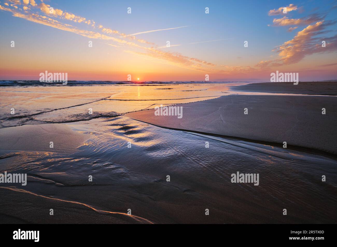 Atlantic ocean sunset with surging waves at Fonte da Telha beach ...