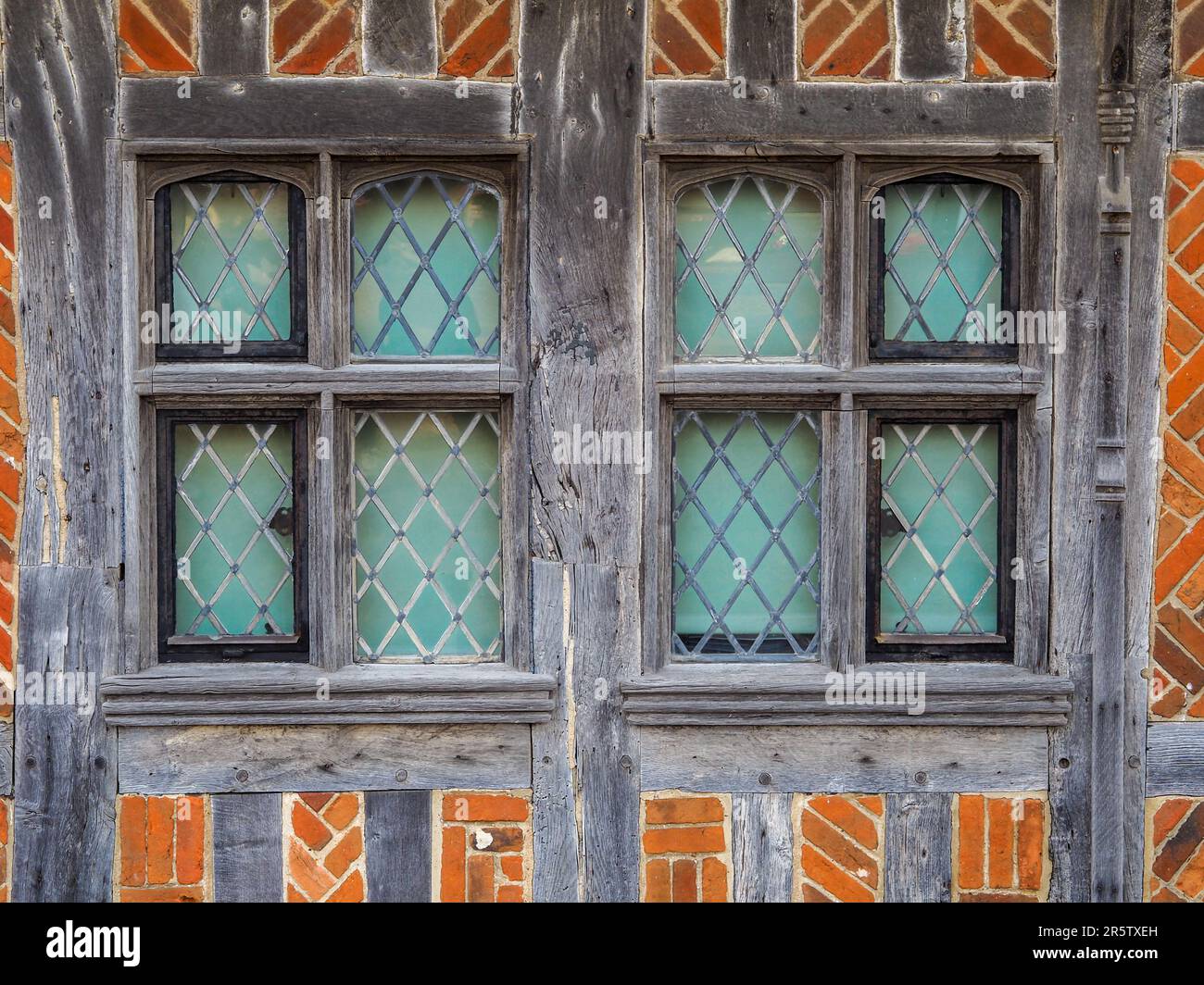 An aged wooden window with bars of an old brick building Stock Photo ...