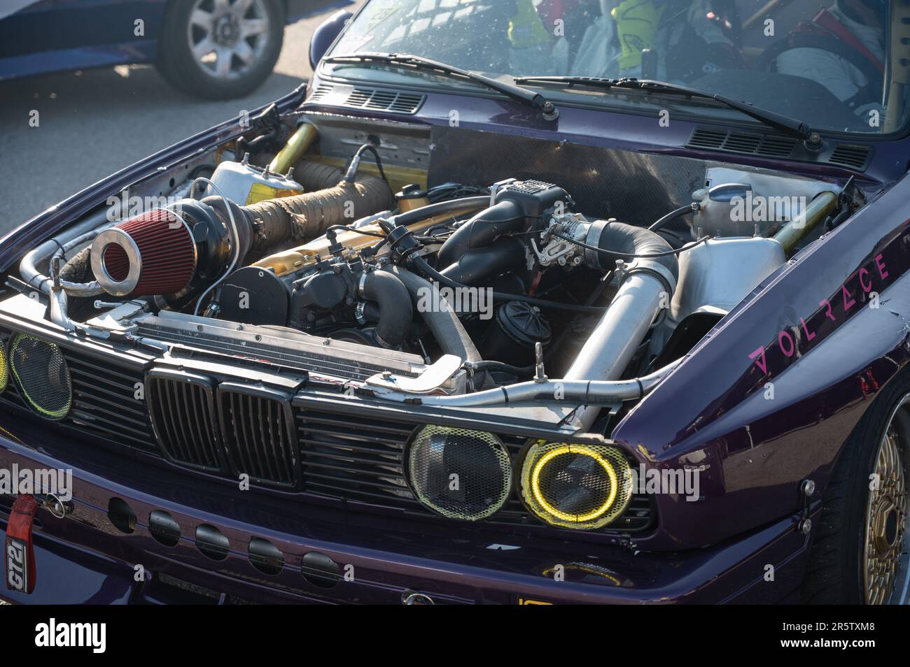 Detail of a racing BMW E30 without the hood, you can see the engine ...