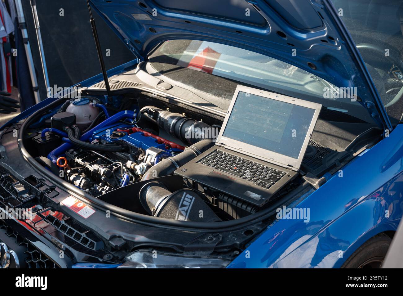 Detail of a technical engineer doing the reprogramming of the engine of ...