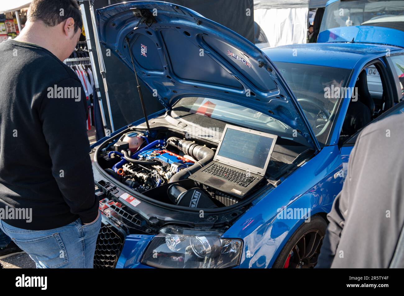 Detail of a technical engineer doing the reprogramming of the engine of ...