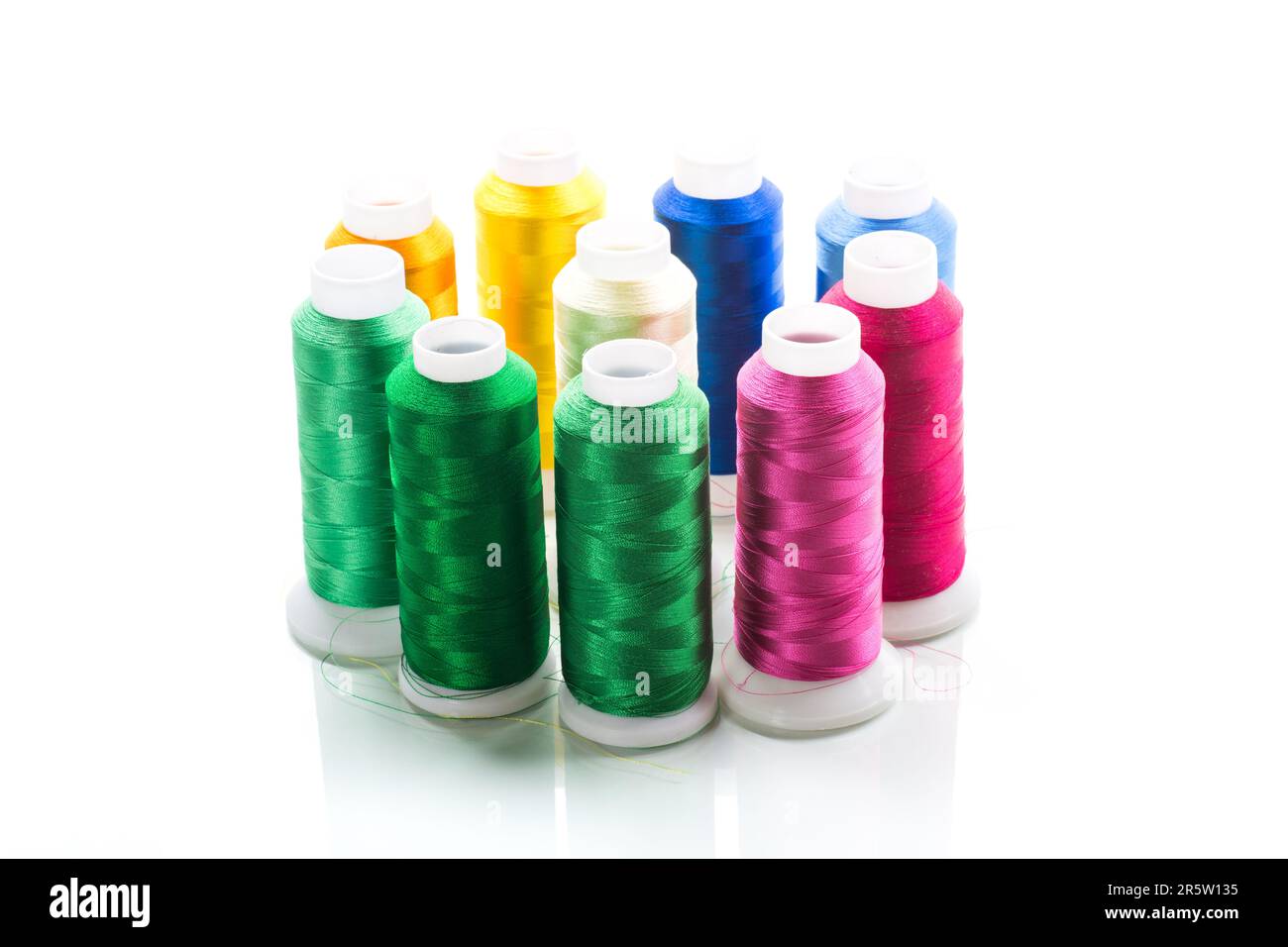 set of different color sewing threads, isolated on white background ...