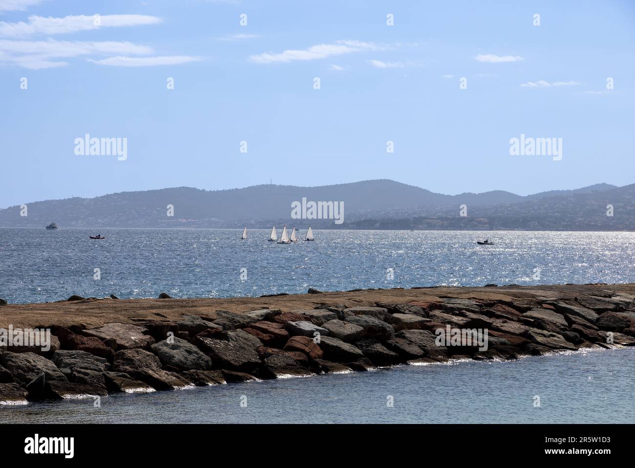 Stone causeway with pedestrians and training sailing ships on the ...