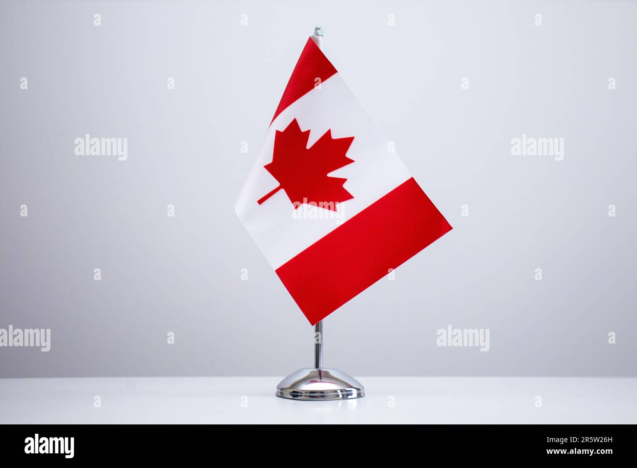 Small national flag of the Canada on a white background Stock Photo - Alamy