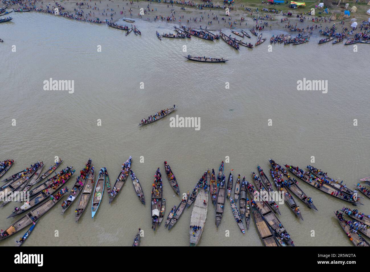 Spectators enjoying a traditional boat race on the Jamuna River ...