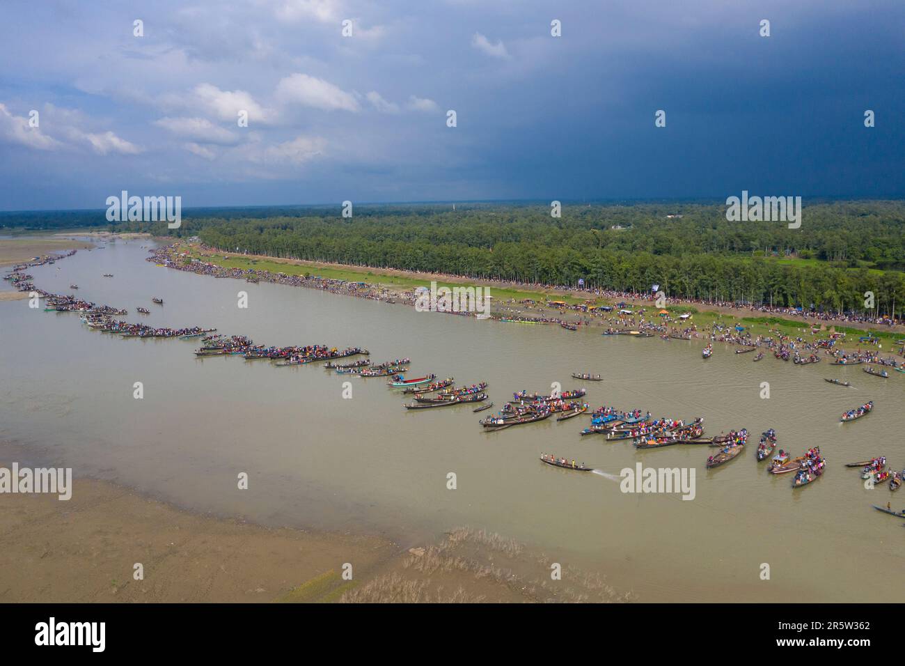 Spectators enjoying a traditional boat race on the Jamuna River ...