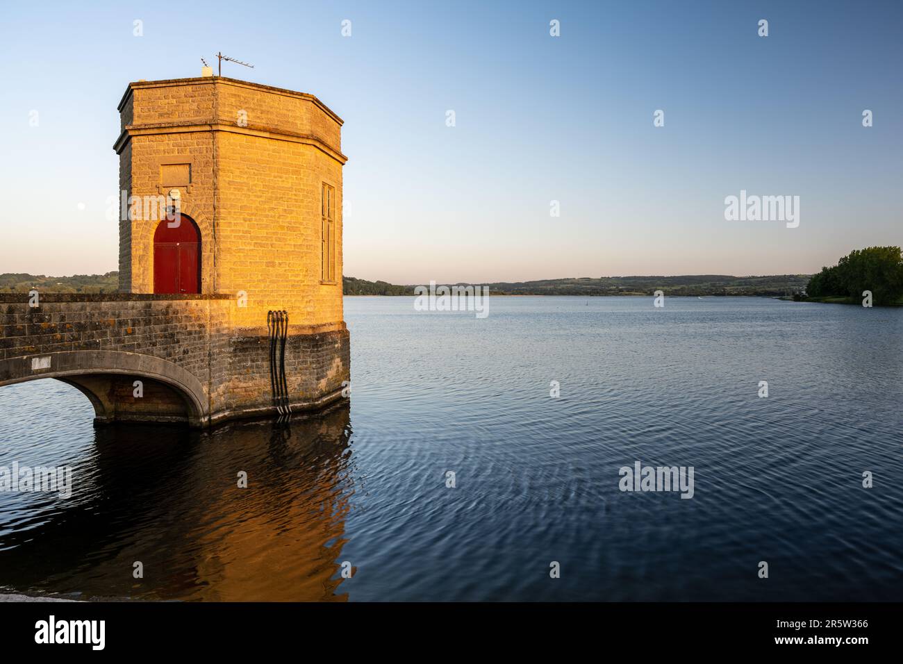 Evening light shines on the tower at Chew Valley Lake reservoir in ...