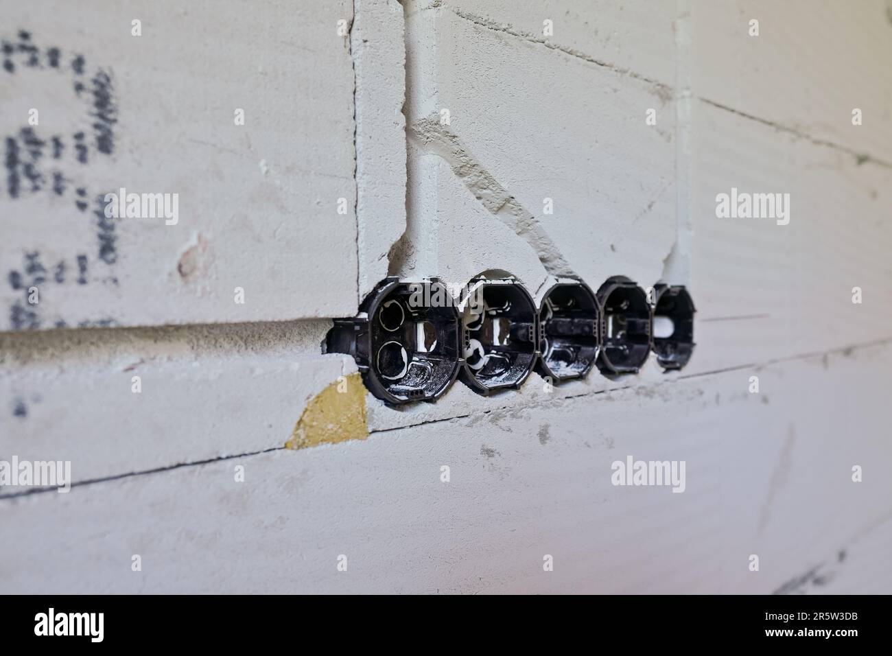 Black plastic boxes with round holes for cables and electric sockets ...