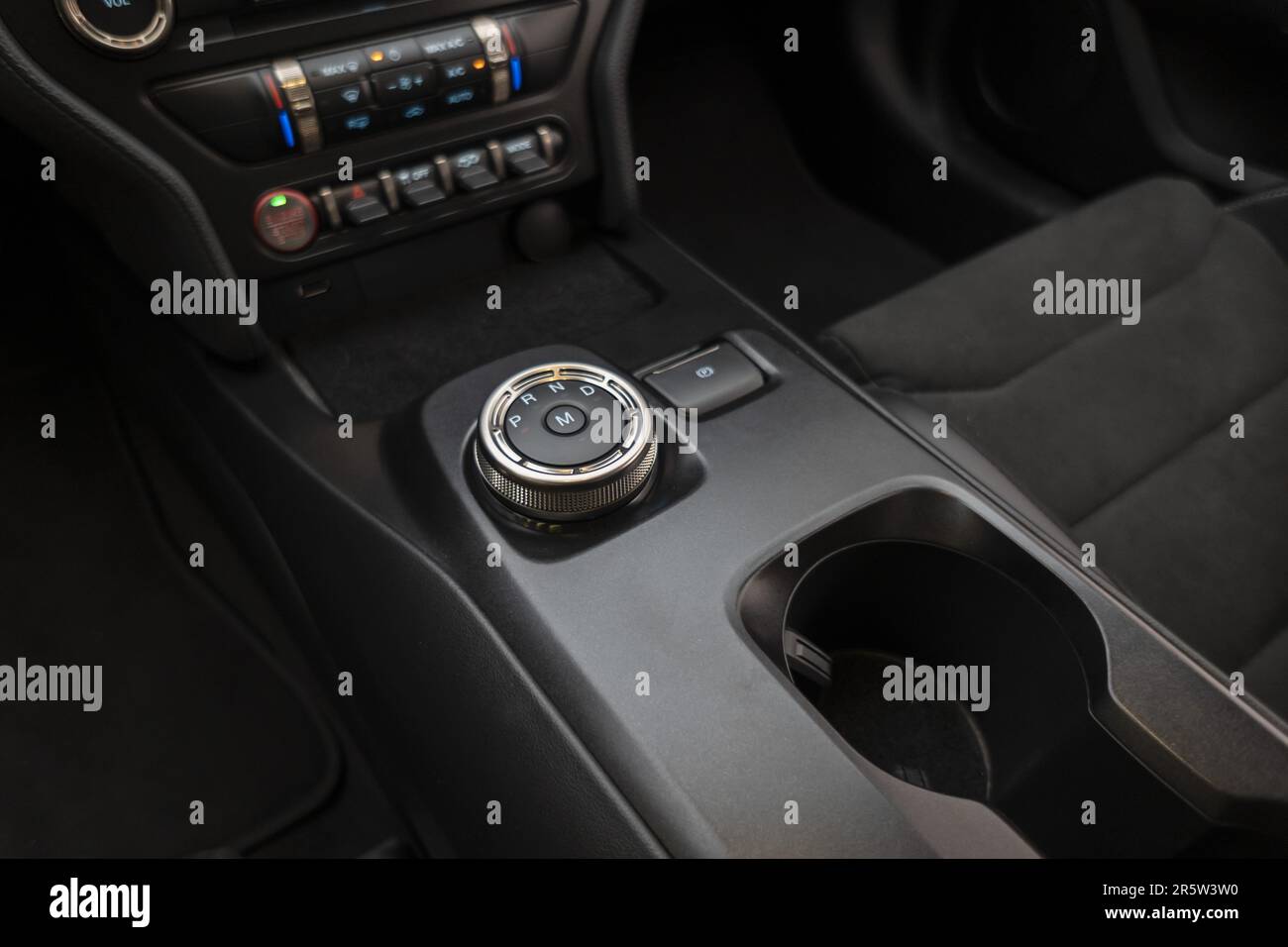 A car's center console with a closeup view of the gear shift and its ...