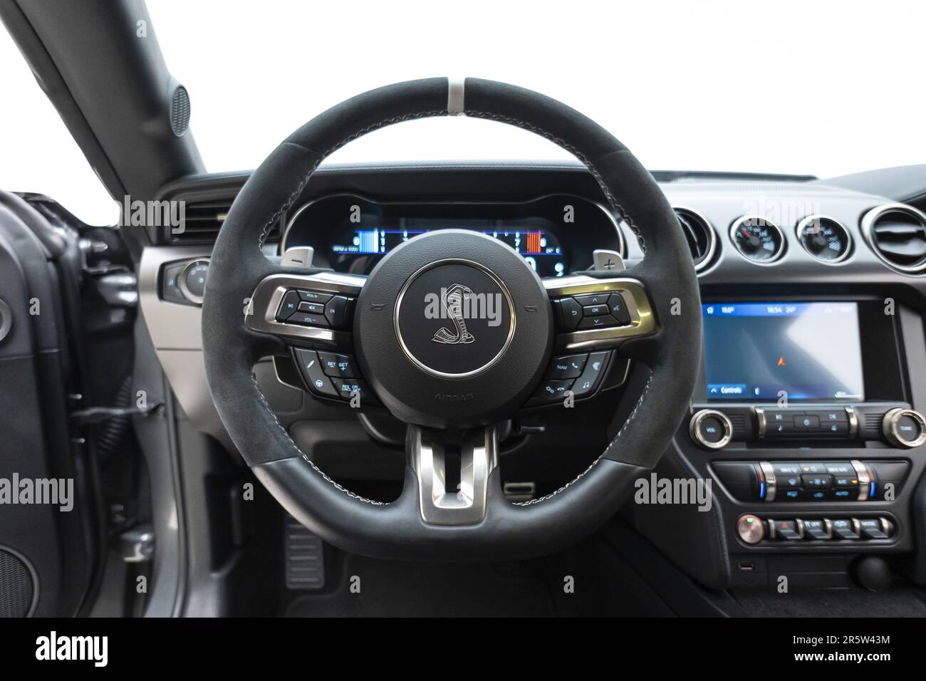 An interior view of a car featuring a black steering wheel and ...