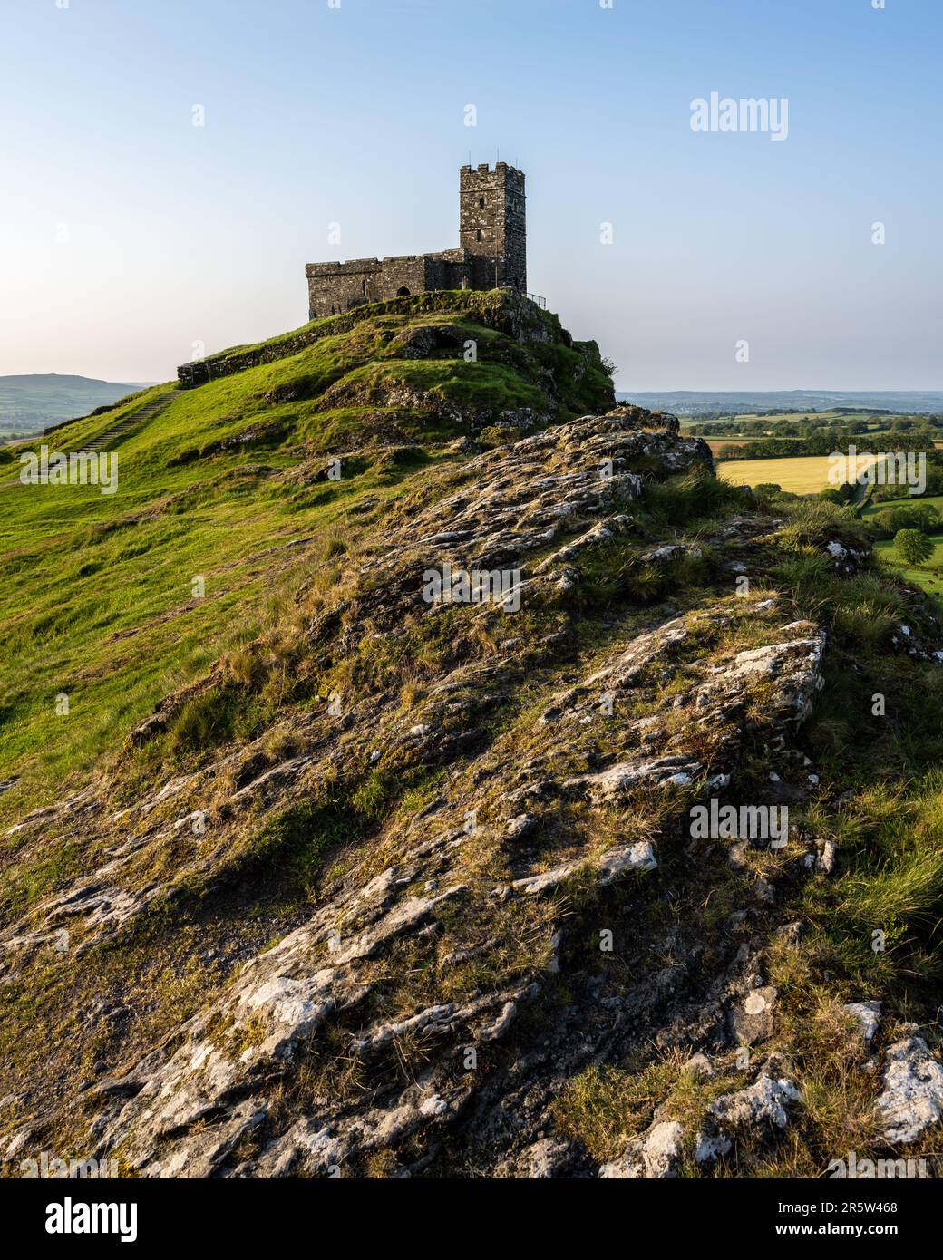 Morning light shines on St Michael's Church on Brent Tor hill in Devon ...