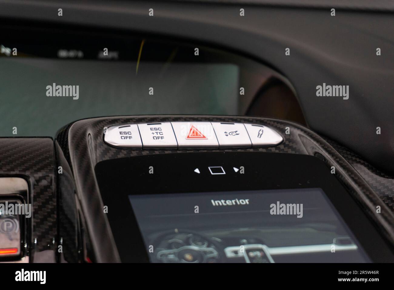 A dashboard view of a car interior, illuminated by the light coming in ...
