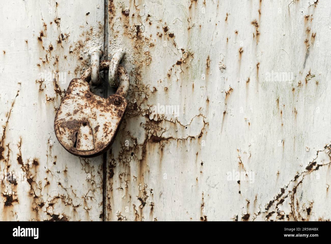 Old rusty lock on metal doors. Lock on the door with an empty place for ...