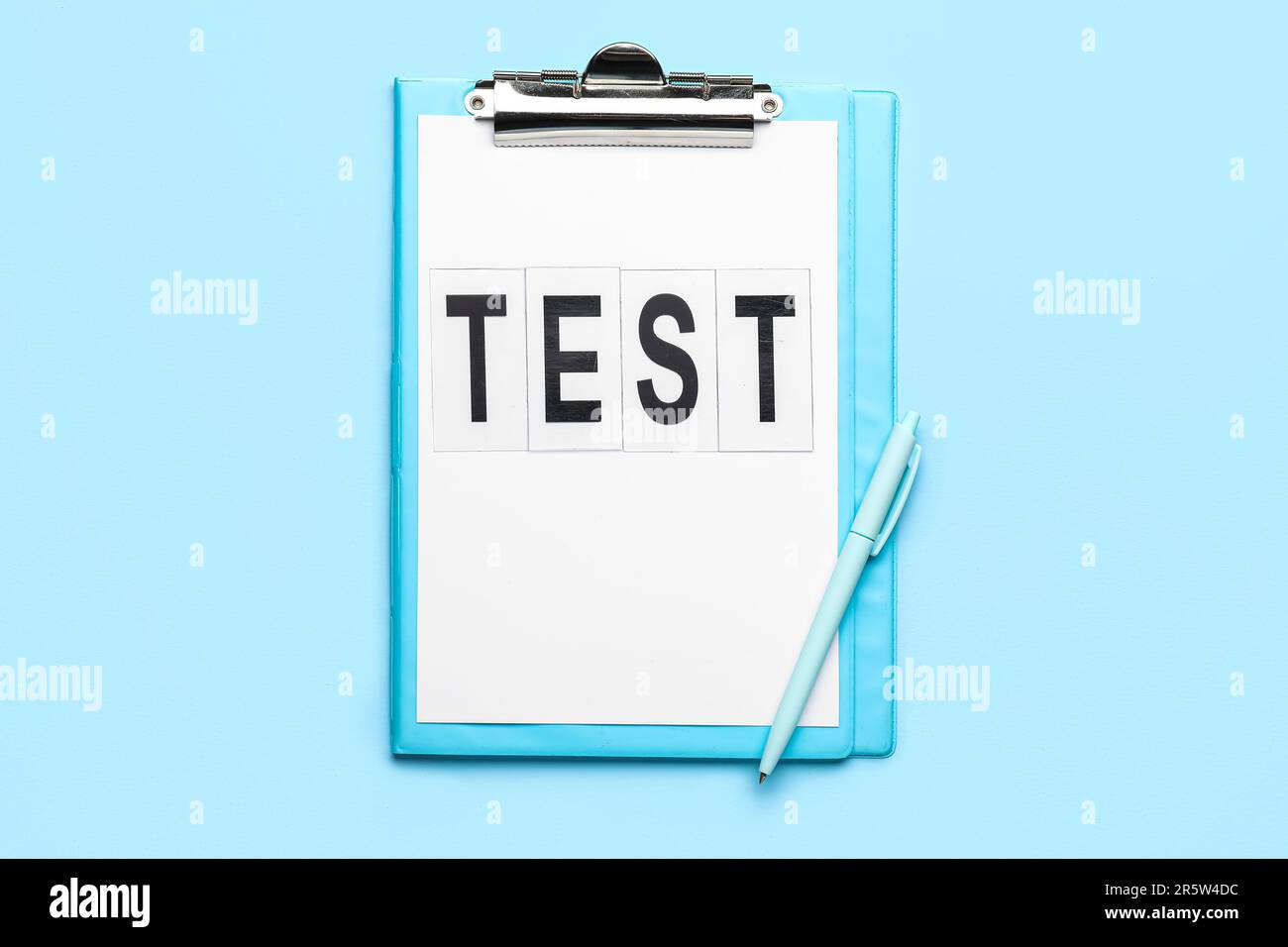Clipboard with word TEST and pen on blue background Stock Photo - Alamy