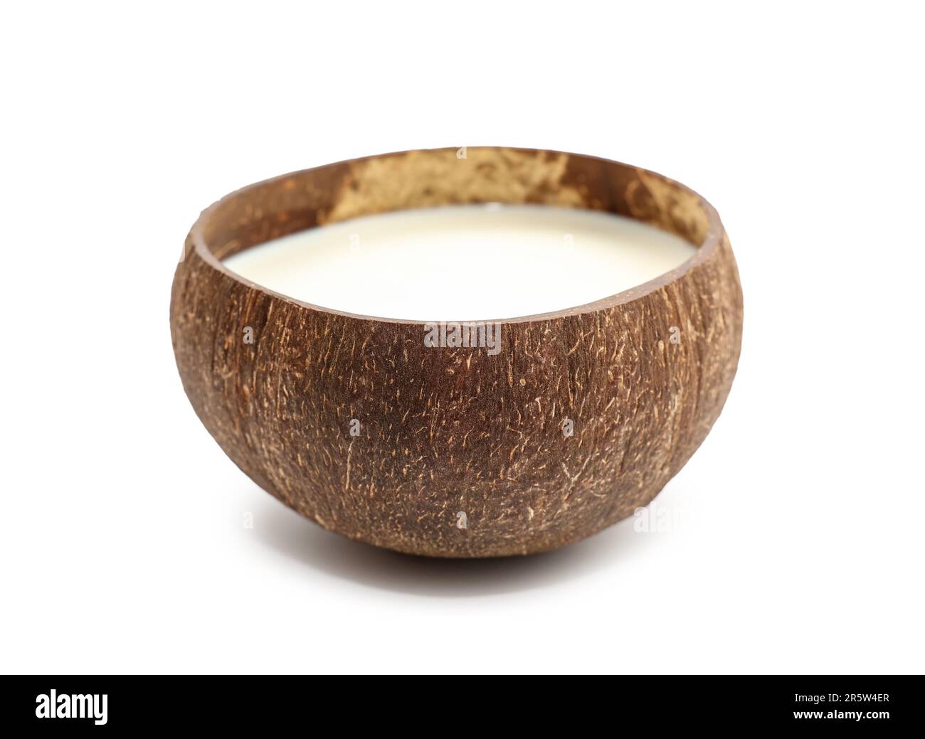Shell with coconut milk on white background Stock Photo - Alamy