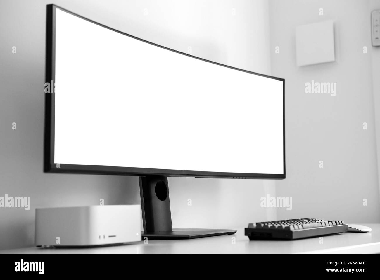 Modern workplace with computer and wi-fi router near light wall Stock ...
