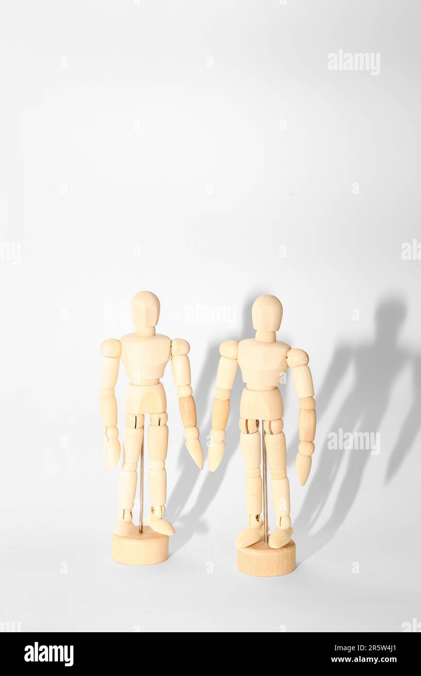 Wooden dummies on white background Stock Photo - Alamy