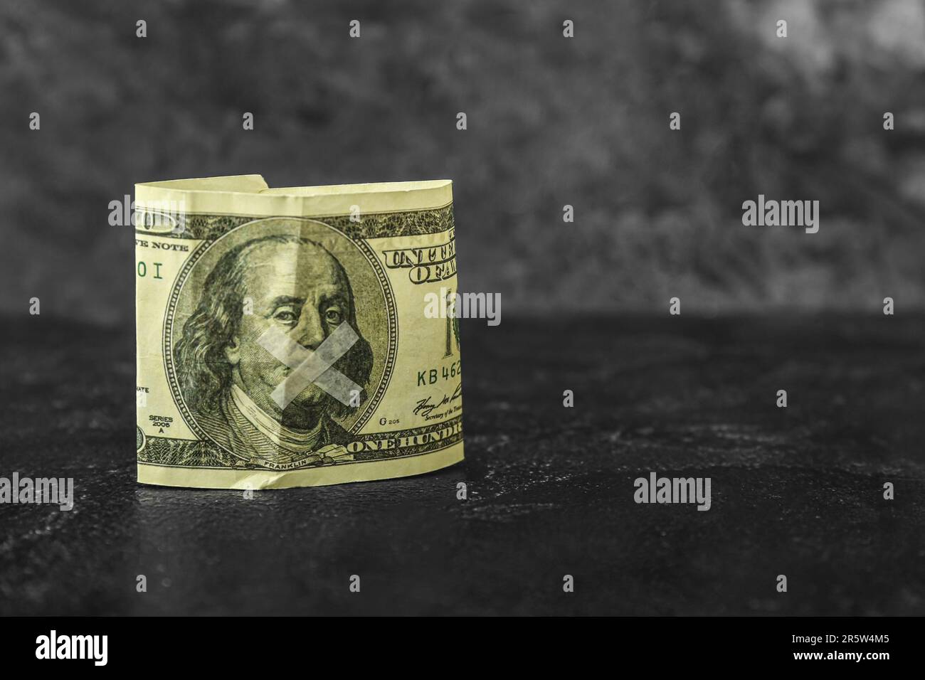 Taped dollar banknote on dark table. Censorship concept Stock Photo - Alamy