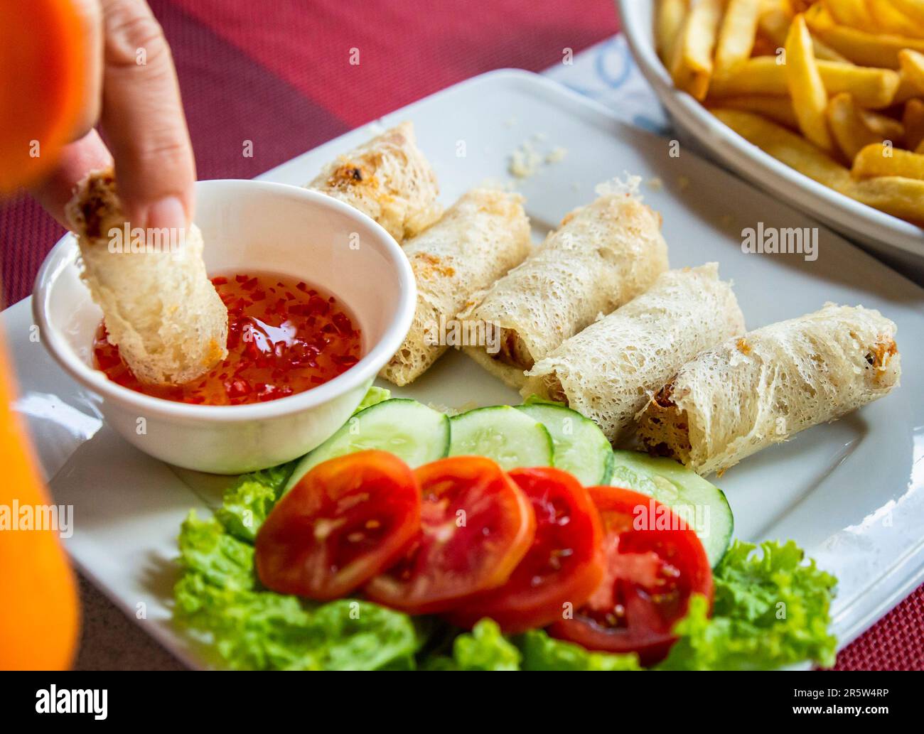 Vietnamese vegetable spring rolls with tomato, cucumbers and red chilli ...