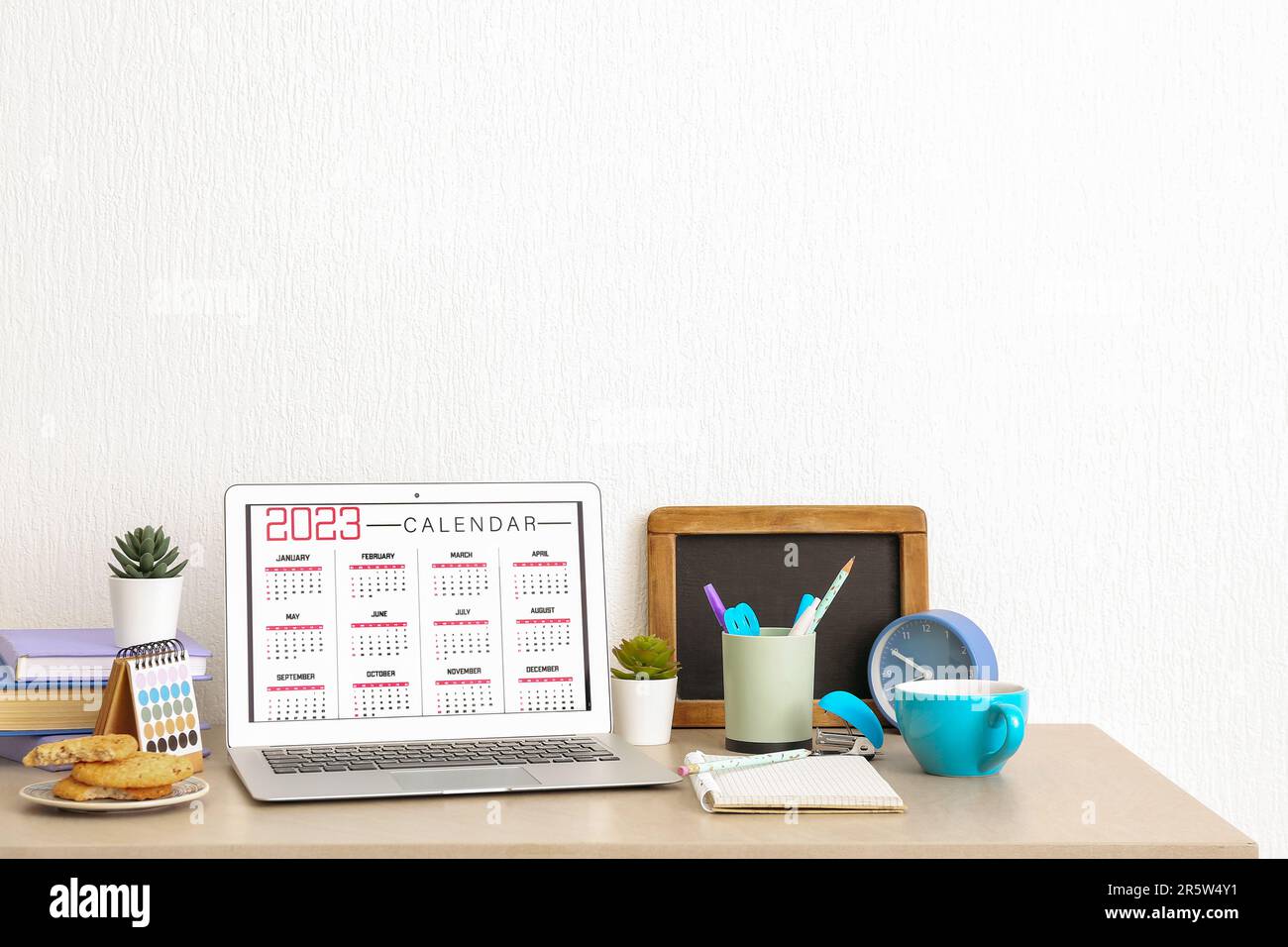 Modern laptop with calendar at workplace Stock Photo - Alamy