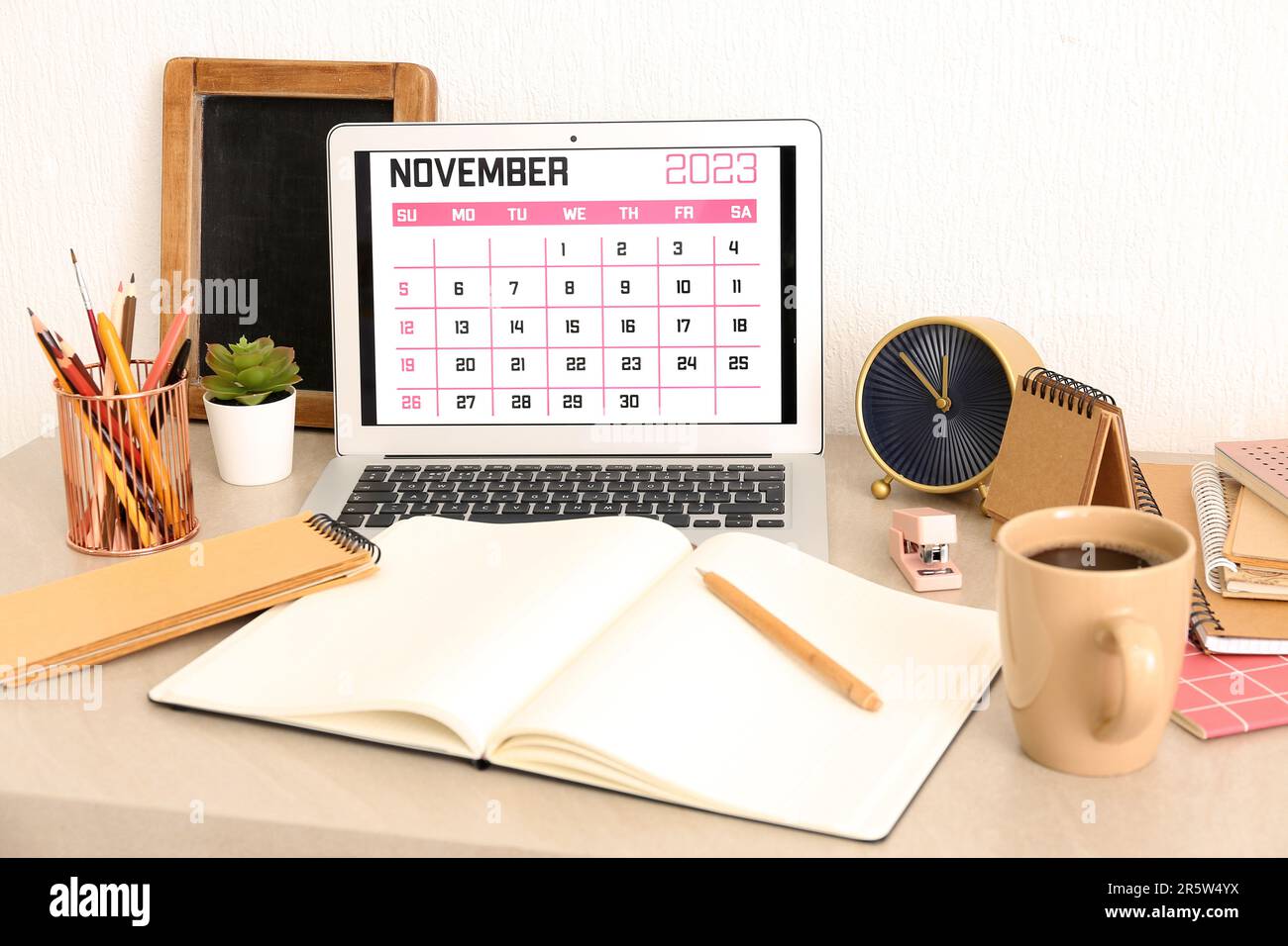 Modern laptop with calendar at workplace Stock Photo - Alamy