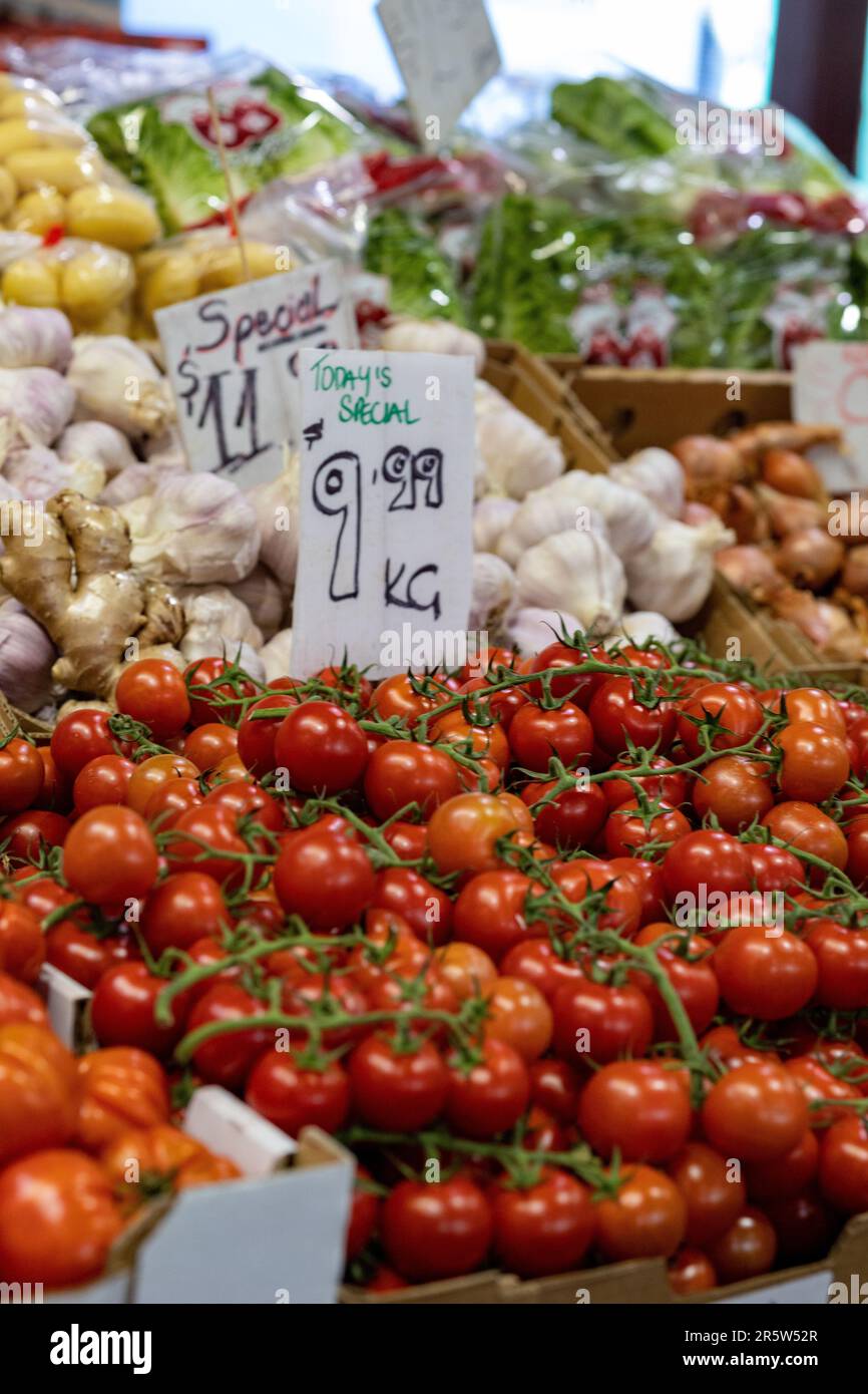 Freshly picked tomatoes being sold at an outdoor market stall Stock ...