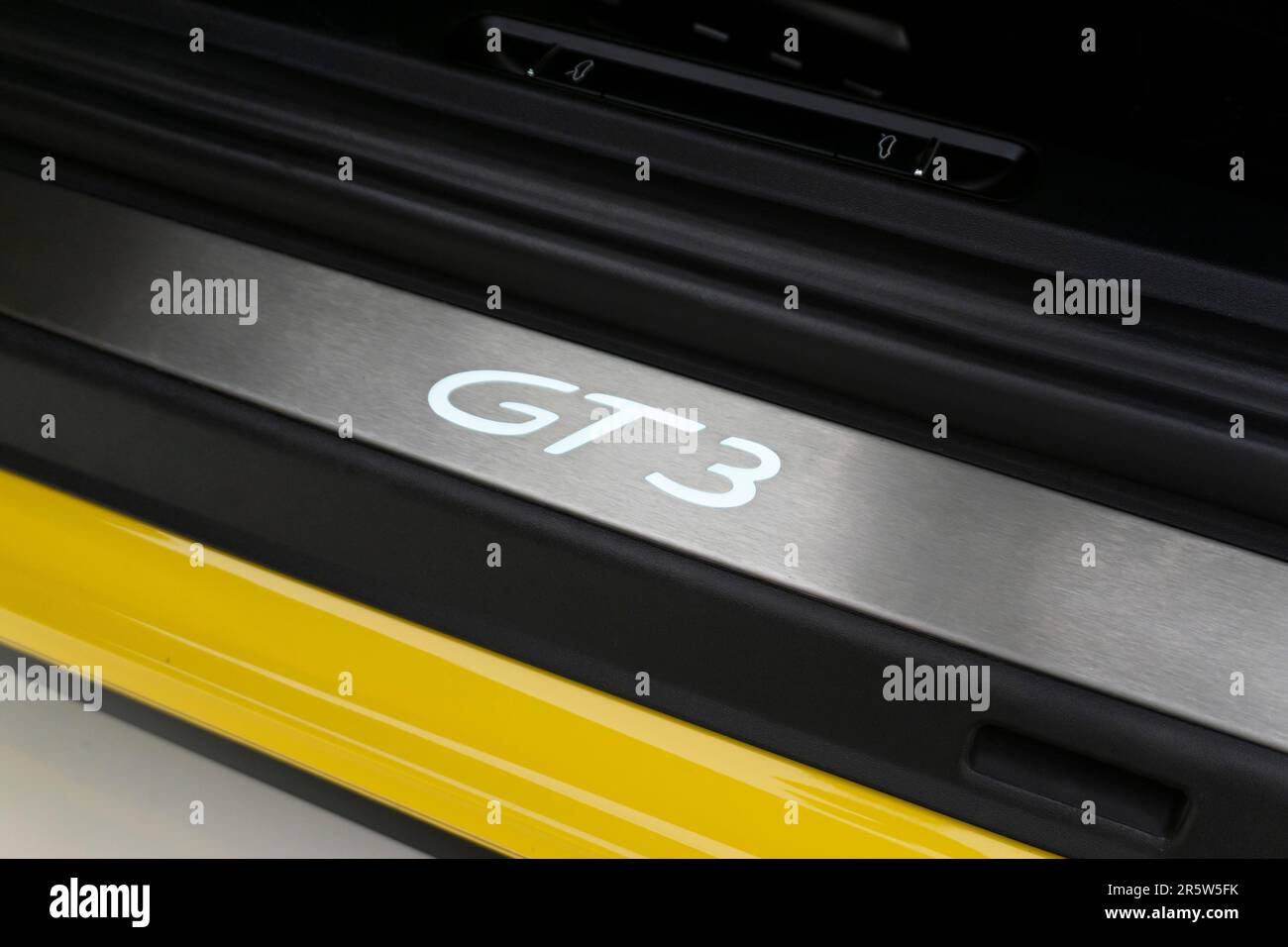 A rear view of a car with chrome doors, focusing on the sill of the ...