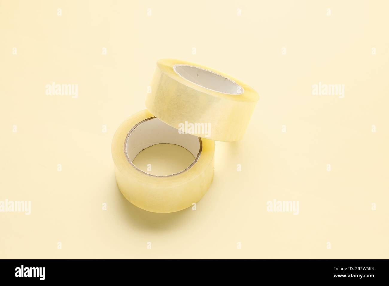 Adhesive tape rolls on beige background Stock Photo - Alamy