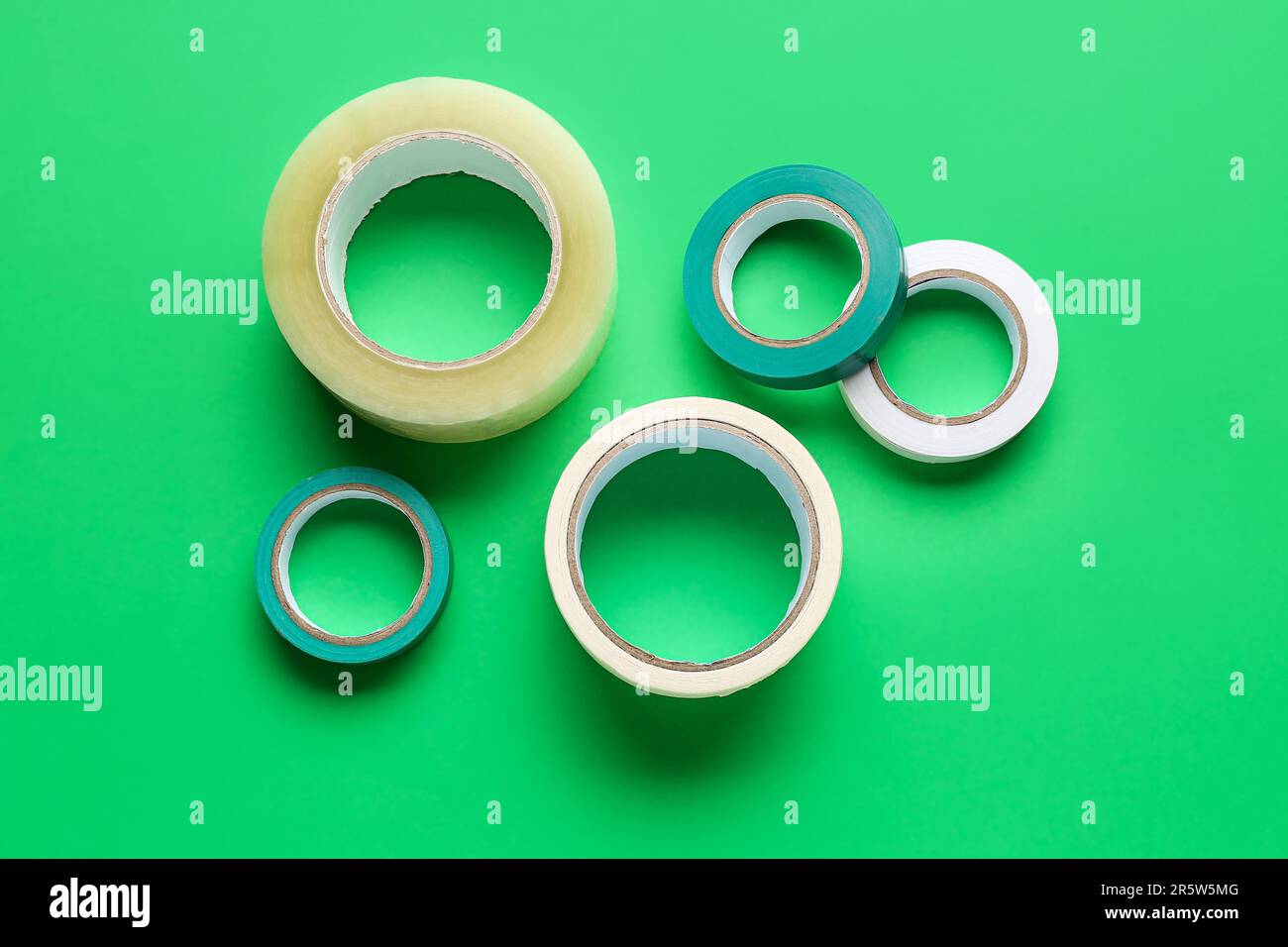 Adhesive tape rolls on green background Stock Photo - Alamy