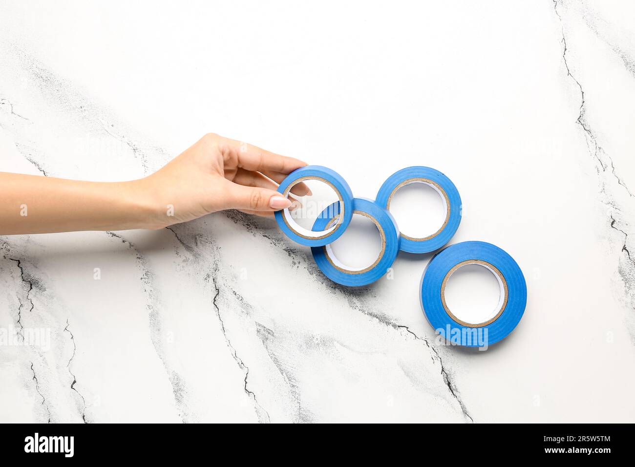 Female hand and adhesive tape rolls on white background Stock Photo - Alamy