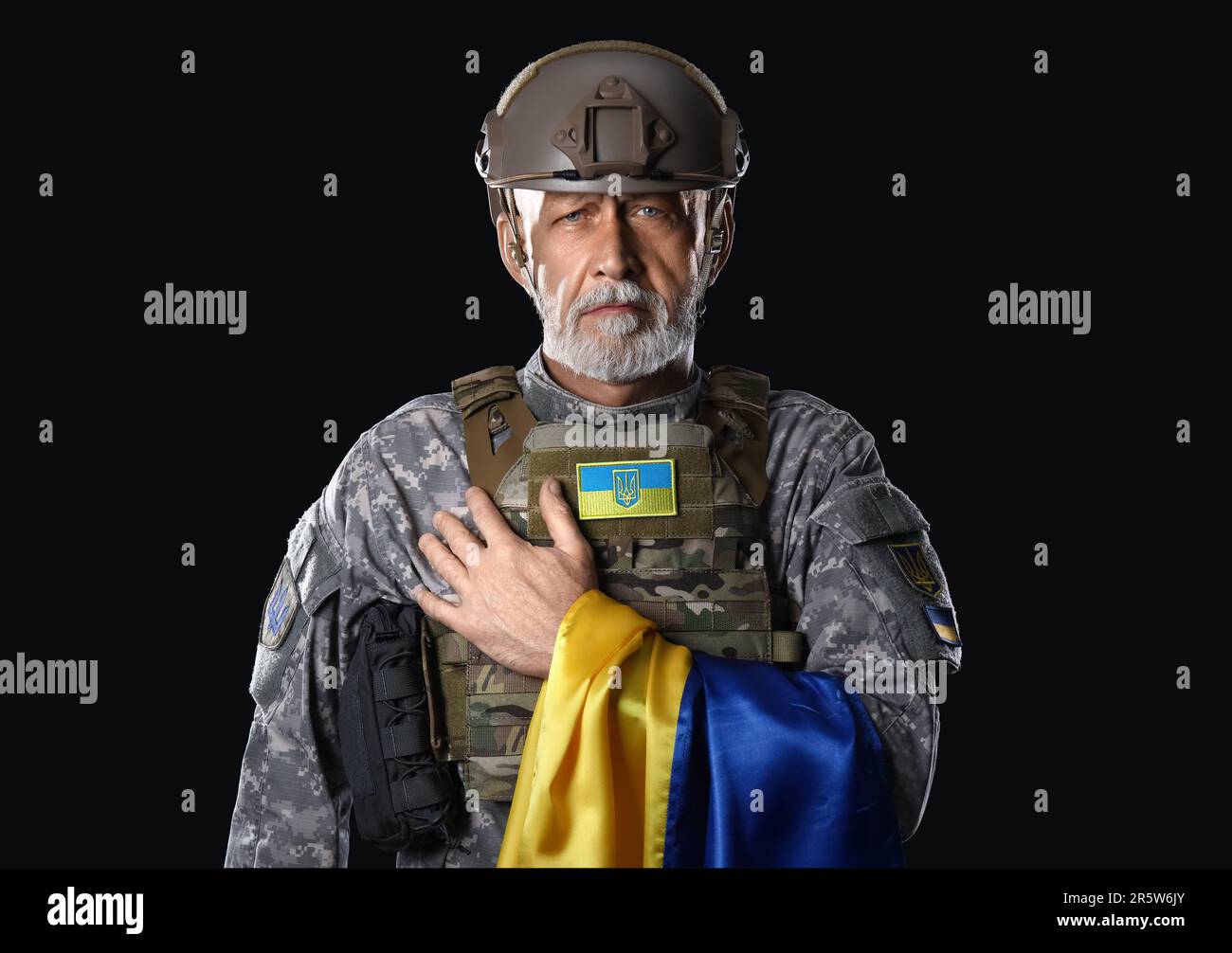 Mature soldier with flag of Ukraine on dark background Stock Photo - Alamy