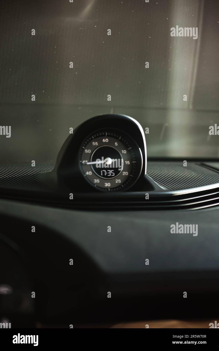 An interior view of a modern car dashboard, featuring a digital ...