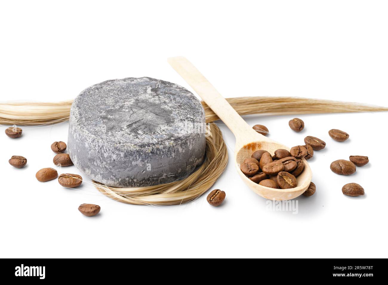 Grey solid shampoo bar with wooden spoon, coffee beans and hair on ...