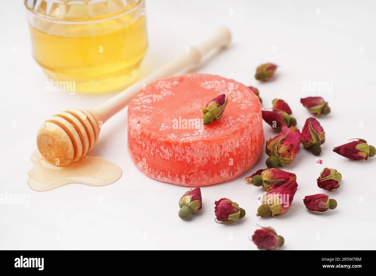 Handmade solid shampoo with honey and dry flowers on light background ...
