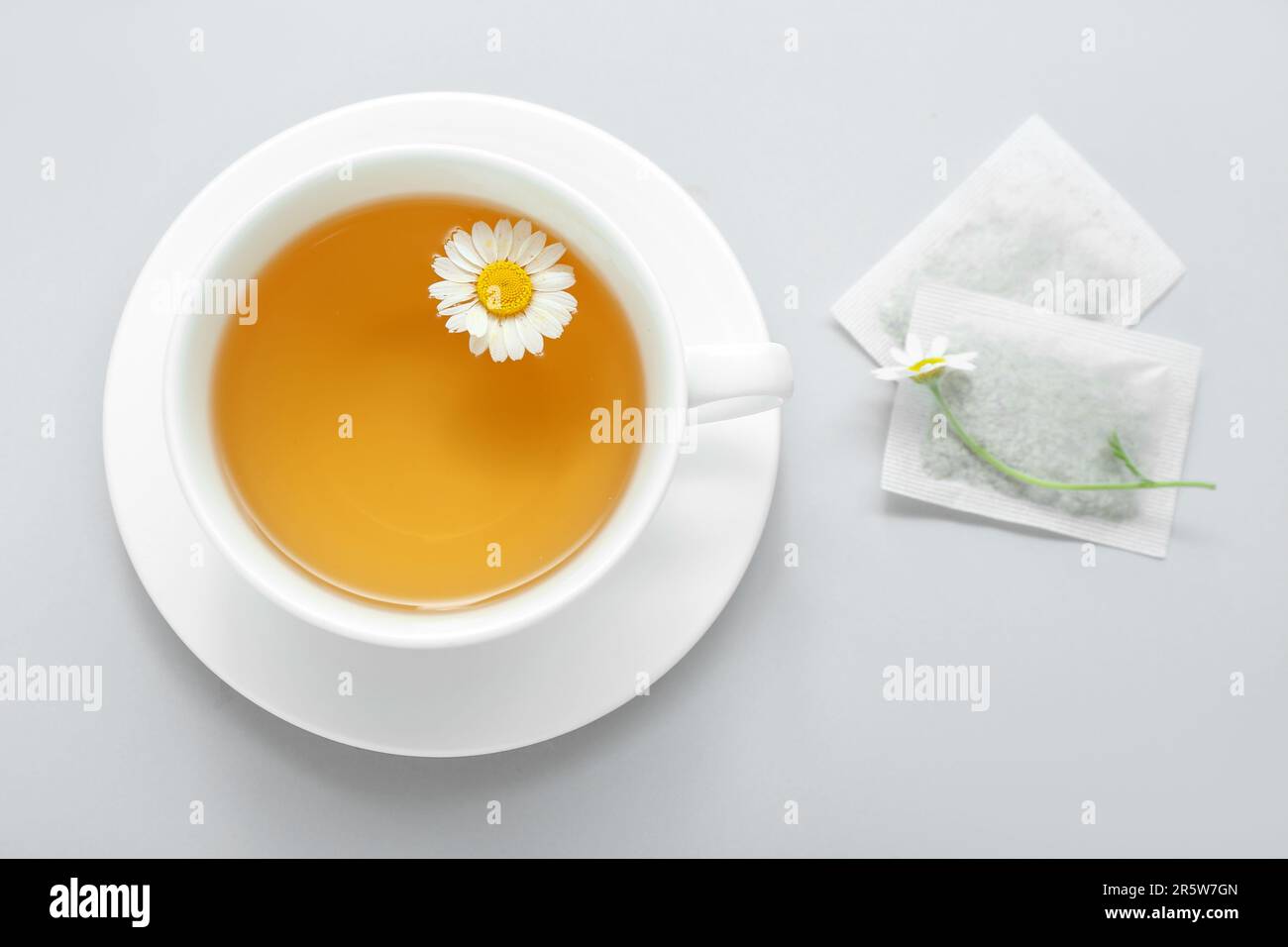 Cup of aromatic chamomile tea on white background Stock Photo - Alamy