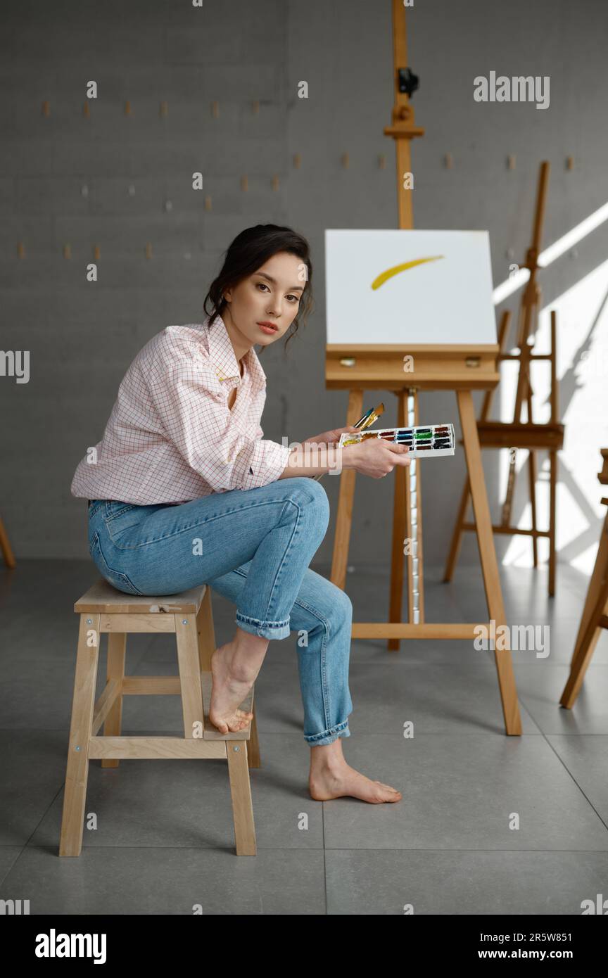 Young woman artist sitting on chair at home artwork workplace Stock ...